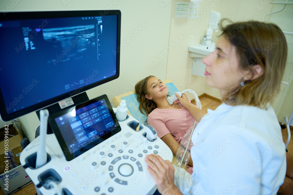 Close up of doctor making thyroid sonogram for kid. Pediatric ...