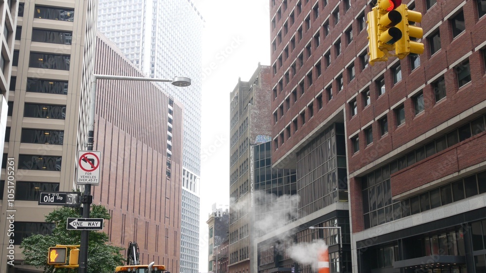 Steam vapor vented on New York City Water street, orange vapour tube ...