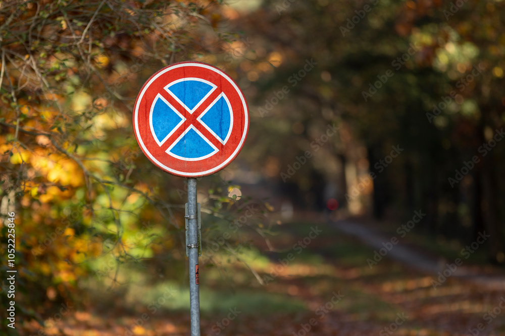 No parking traffic sign on the side of the road with bright red circle ...