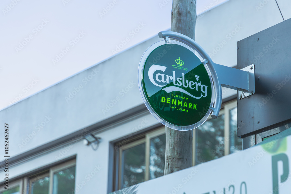 Carlsberg logo sign at a bar. The Carlsberg Group is a globally ...