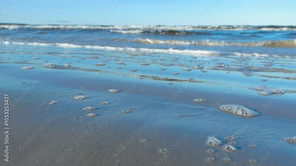 Slowly moving footage of bubbly water close up as foaming sea waves ...