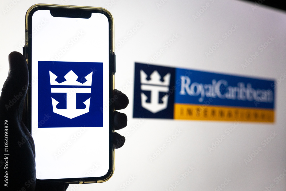 Silhouette of Hand Holding iPhone with Royal Caribbean Logo in Front of ...