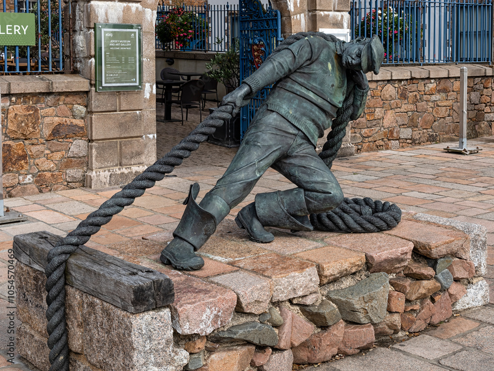 JERSEY, CHANNEL ISLANDS - AUGUST 06, 2021: Statue of a seaman hauling ...