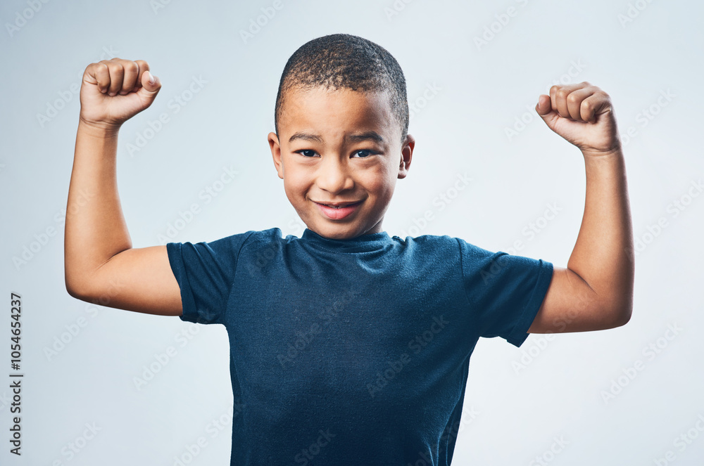 Portrait, boy and studio with flexing biceps for power, strength and ...