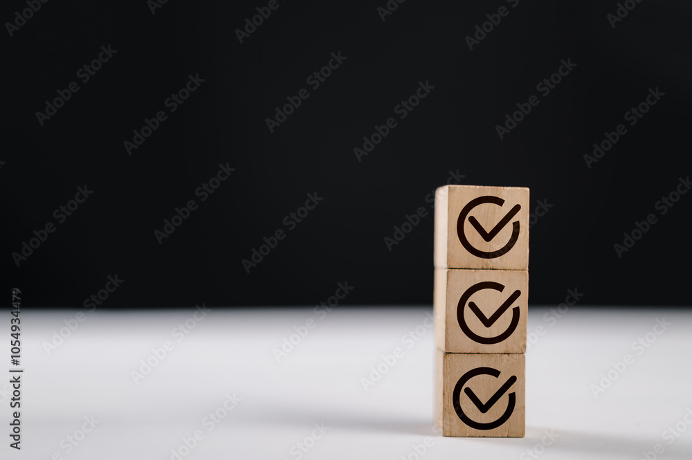 Check mark icons for jobs list on the face of wooden stacked blocks ...