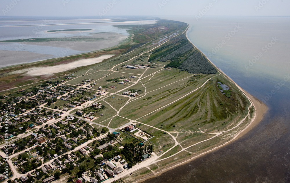 Aerial view of beautiful coastal village with homes and road alongside ...