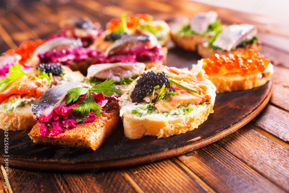 Cocktail canapes with smoked salmon, herring, cream cheese and caviar ...