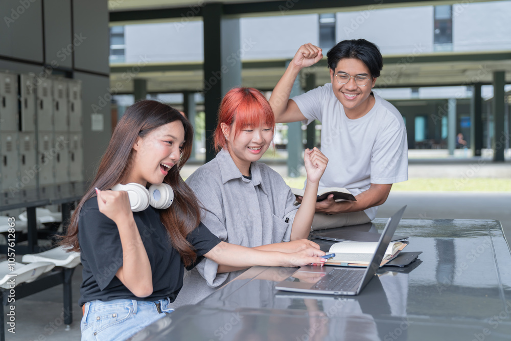 Three cheerful asian university students are celebrating their academic ...