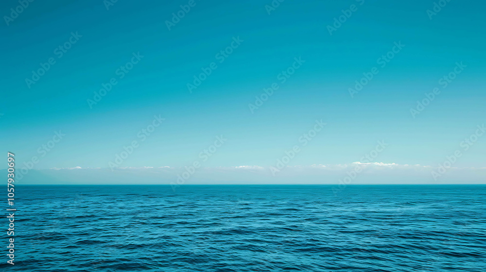Deep blue ocean with a clear blue sky and distant clouds. The water is ...