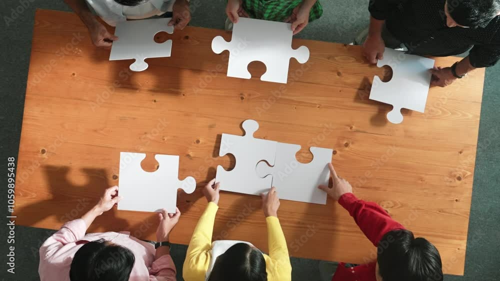 Top down view of skilled business people assemble jigsaw puzzle on ...