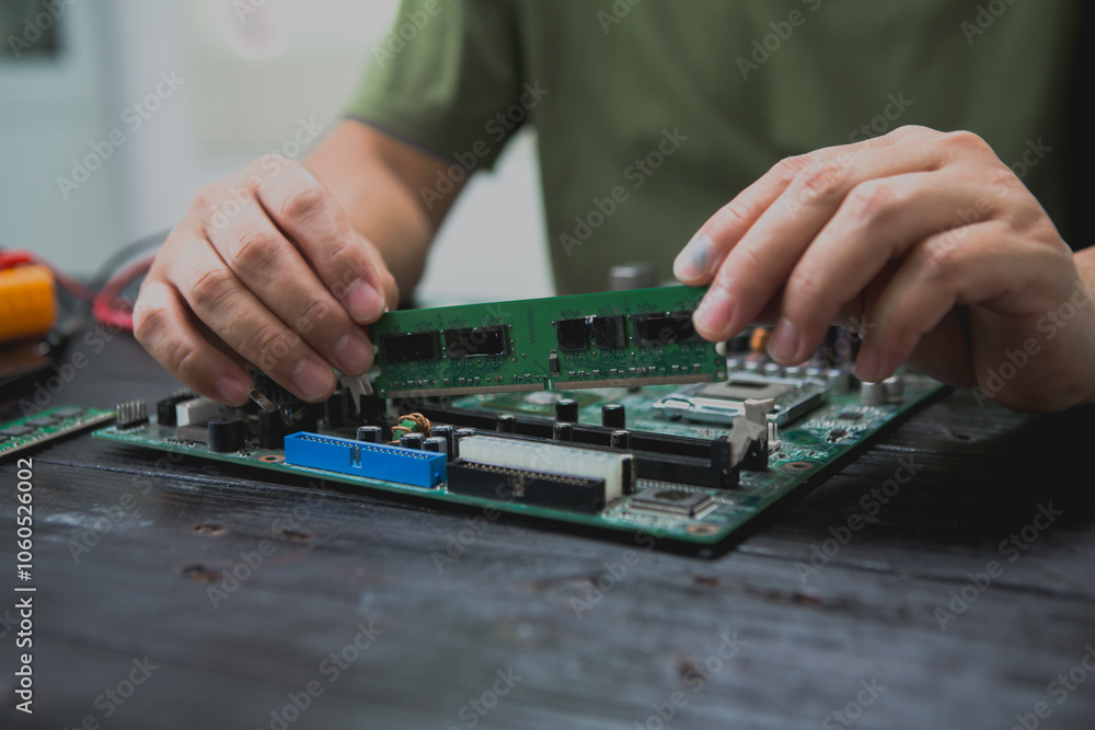 Asian male computer repairman is checking and fixing hardware problems ...