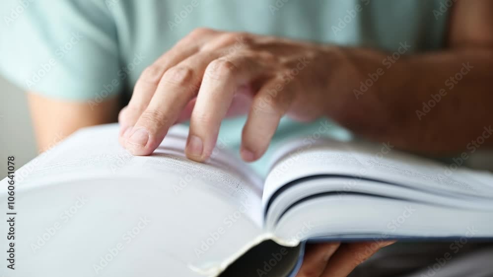 Closeup of man searching for the term in the dictionary, finger ...