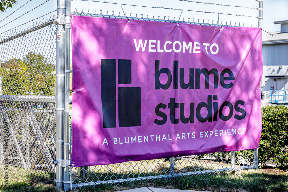 Charlotte, NC, USA-Oct. 20, 2024: Blume Studios flag hung on gate. "Welcome to blume studios, A ...