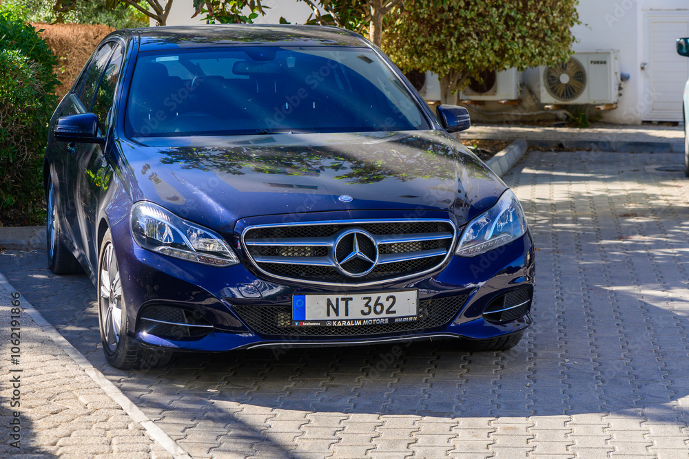 Gaziveren Cyprus -20.10.2024 A sleek dark blue car parked elegantly ...