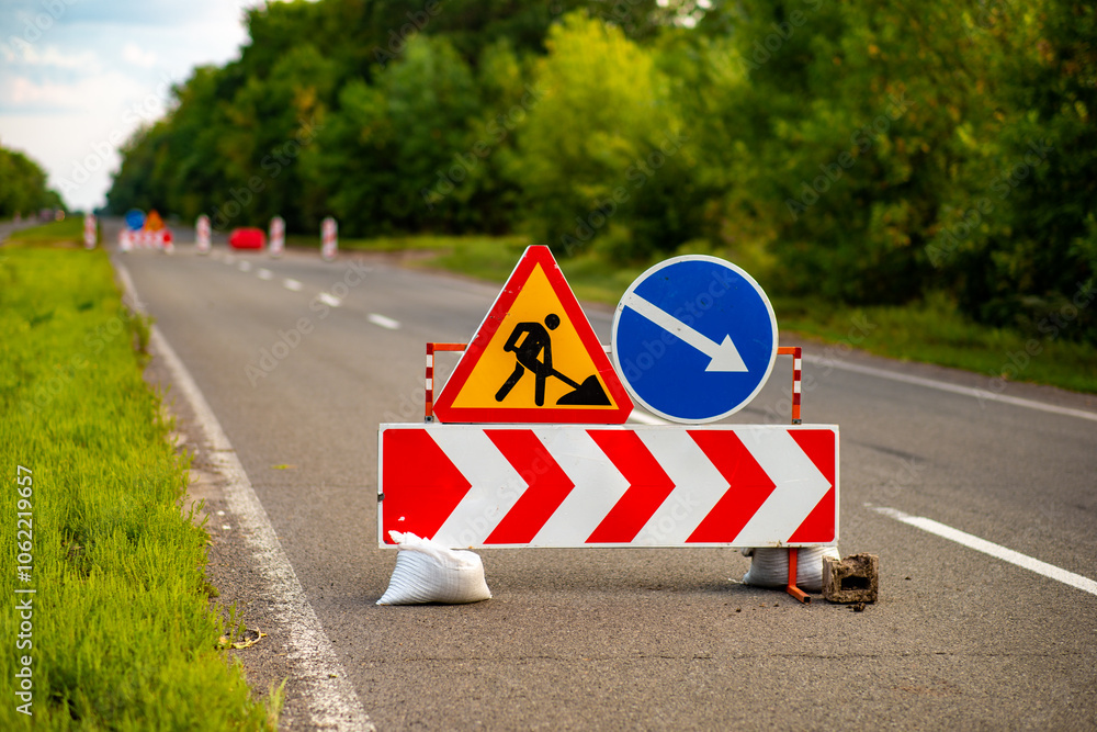 Road signs indicating construction work ahead, alerting drivers to ...