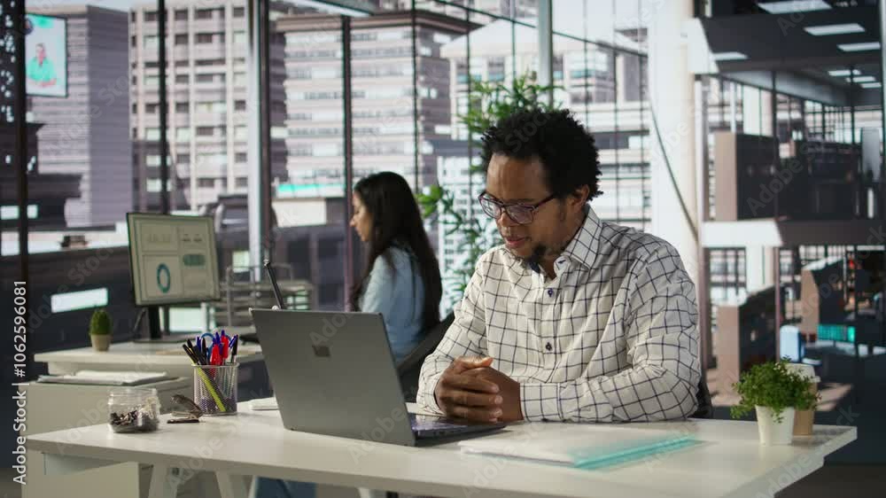 Black man employee joins a telecommuting session at his office desk ...