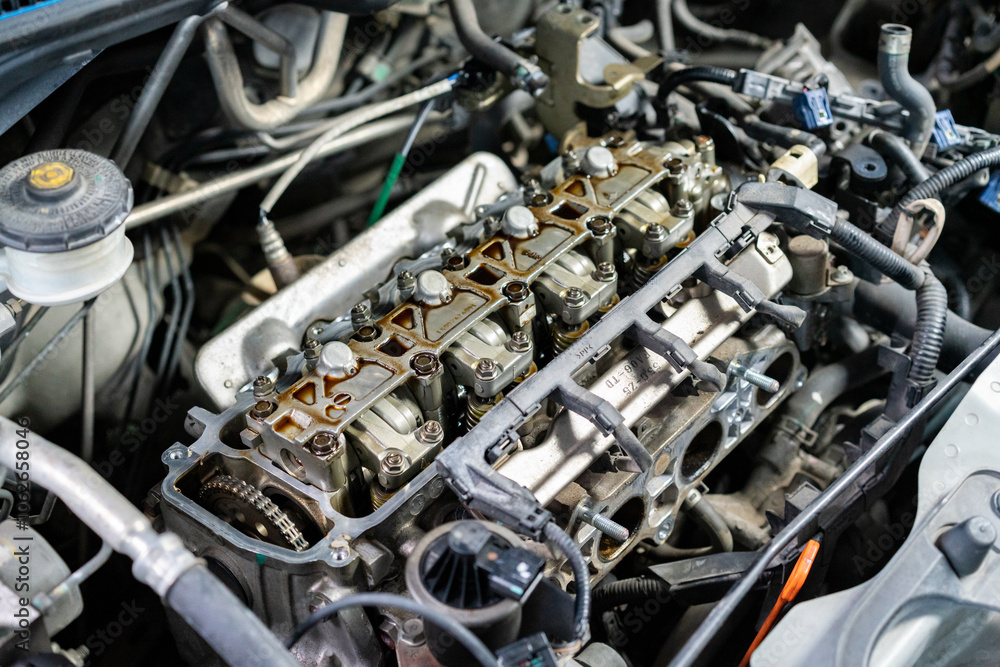 Disassembled the car engine to replace the valve cover gasket, adjust ...