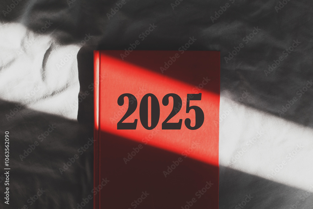 red diary with the inscription text 2025 top view, concept of planning ...