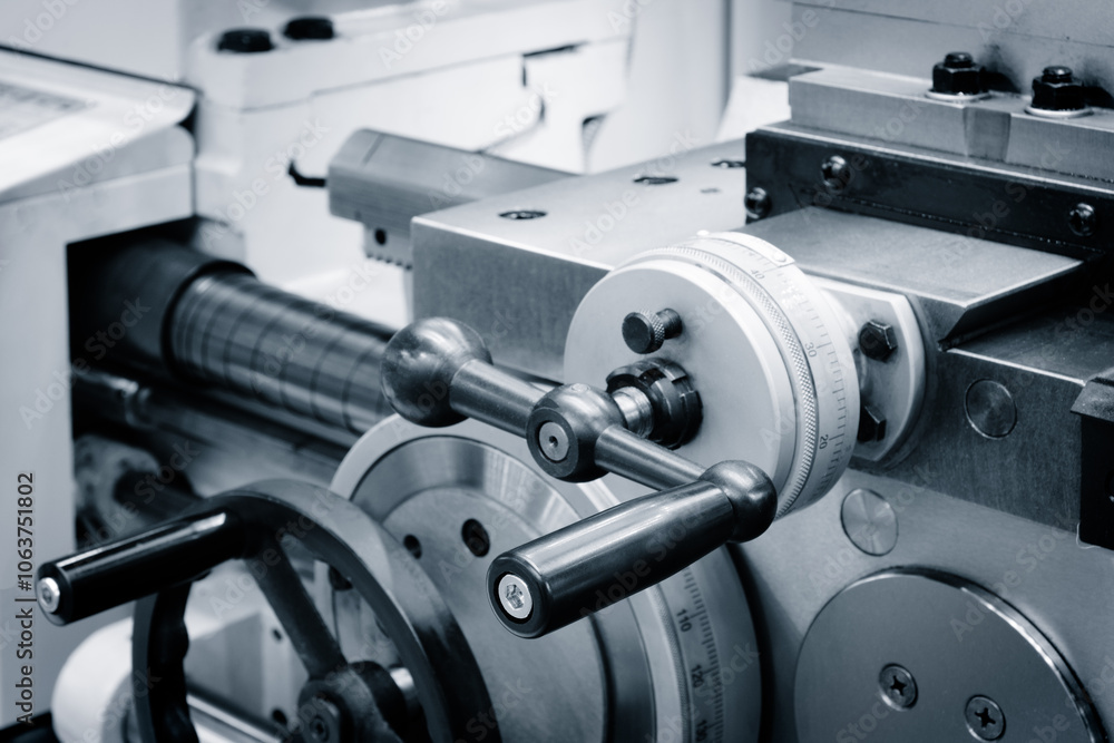 Metalworking lathe with handle and dial vnite. The dial is marked with ...