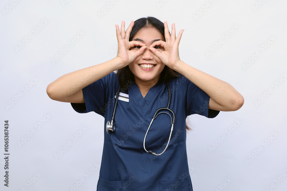 Impressed funny and cute young Asian woman nurse wearing blue uniform ...