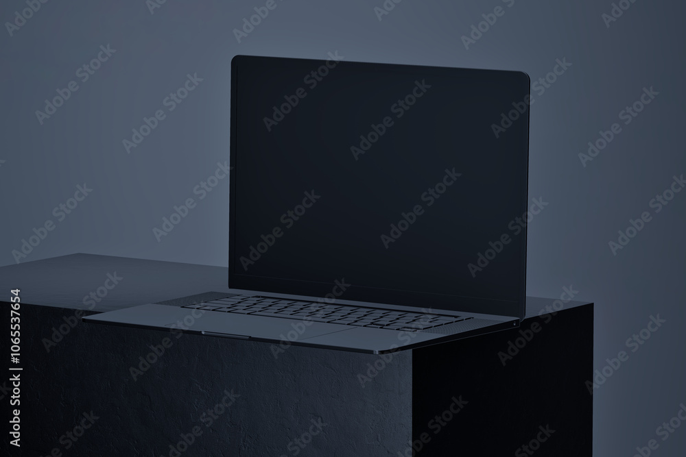 Laptop Minimalism: A sleek, black laptop rests on a minimalist dark ...