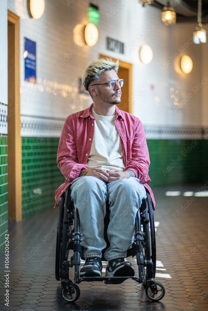 Somber anxious disabled man in wheelchair sits alone in hospital lobby ...