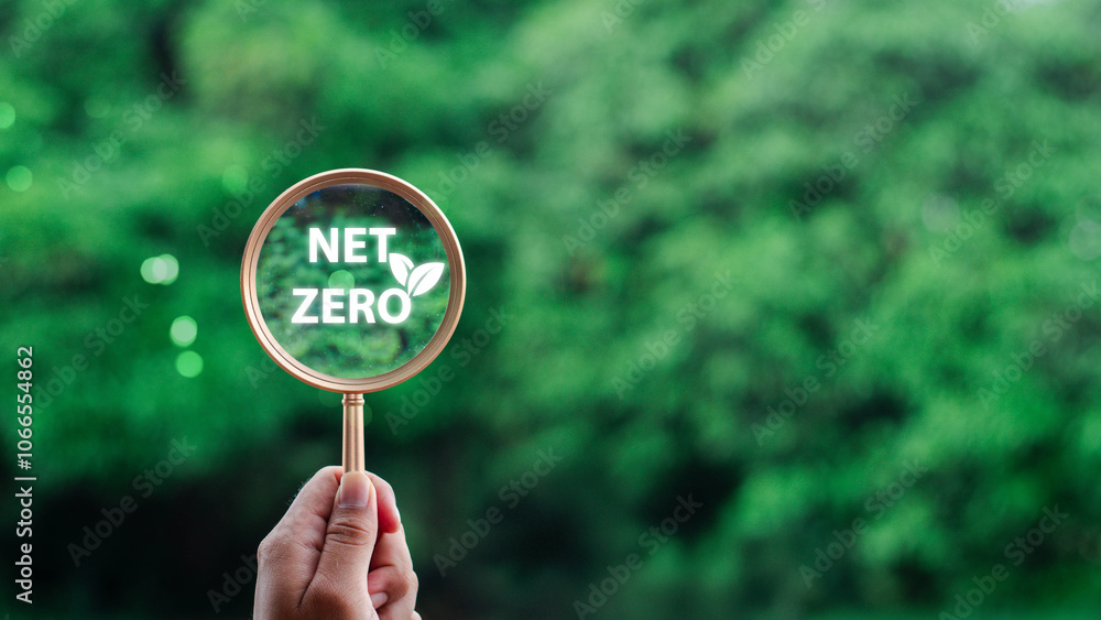 hand holding magnifying glass with CO2 reduction icon inside.A clean ...