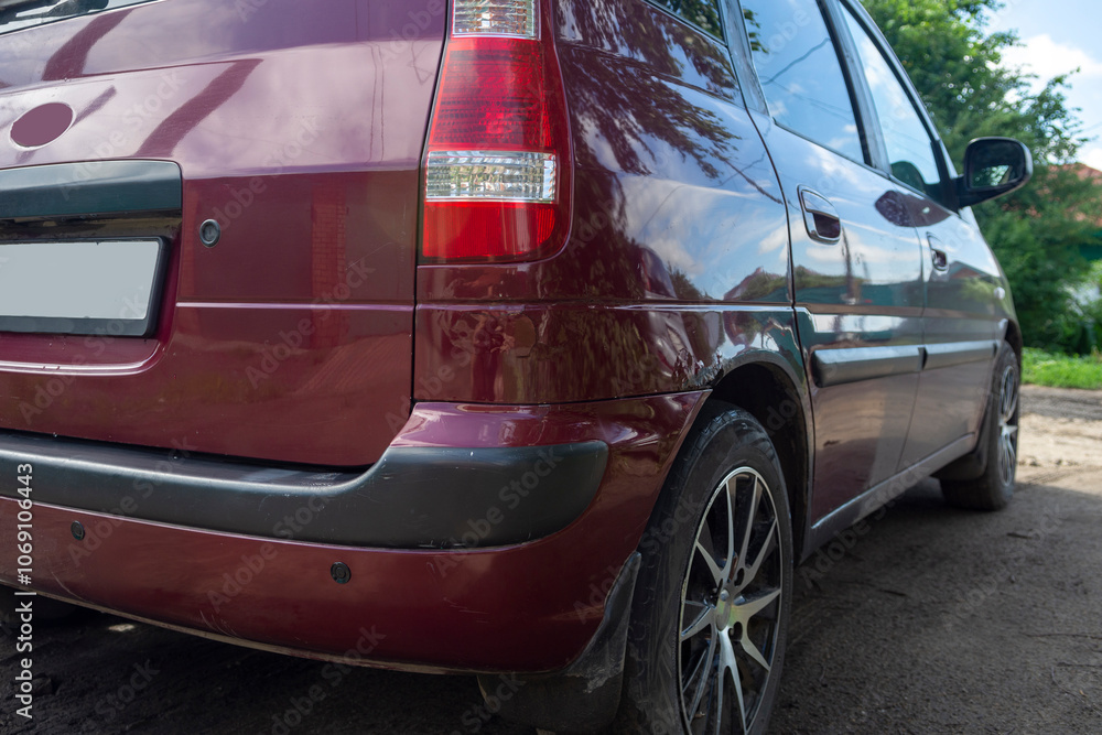 Rusty car. Red old rusty car. Fragment of a red wing of an old car ...