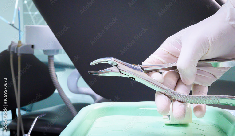 Dentist's hand taking extraction forceps for dentistry. Dentistry ...