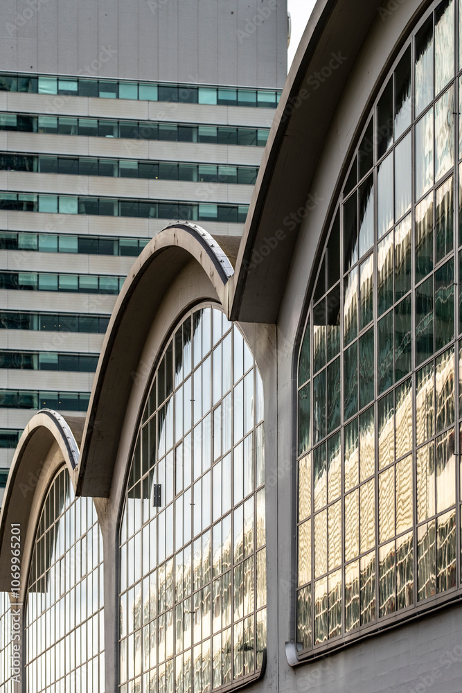 Rows of arched, reflective windows echo a modern cityscape, juxtaposing ...