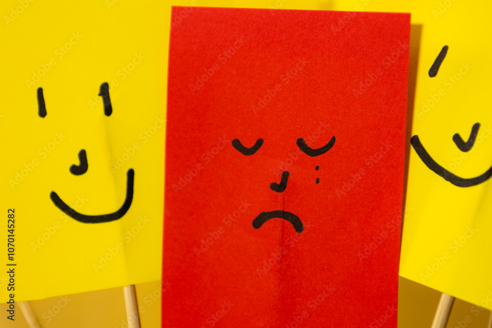 Poster Close up of red paper with sad depressive face surrounded by ...