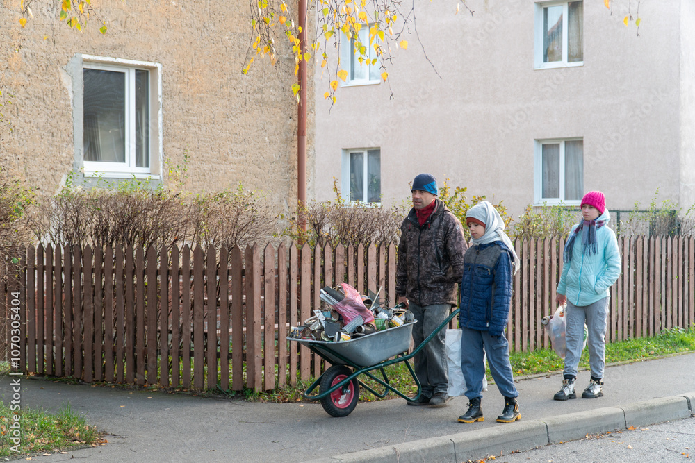 children carry a wheelbarrow with metal, poor children earn money ...