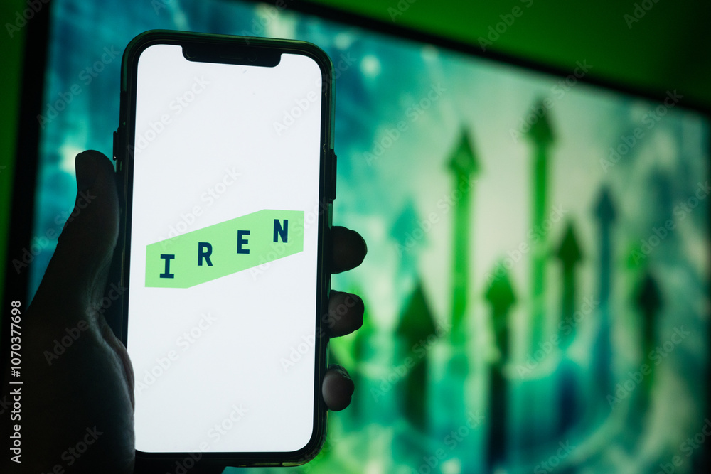 Hand Holding Phone with Iren (IREN) Logo and Monitor in the Background ...