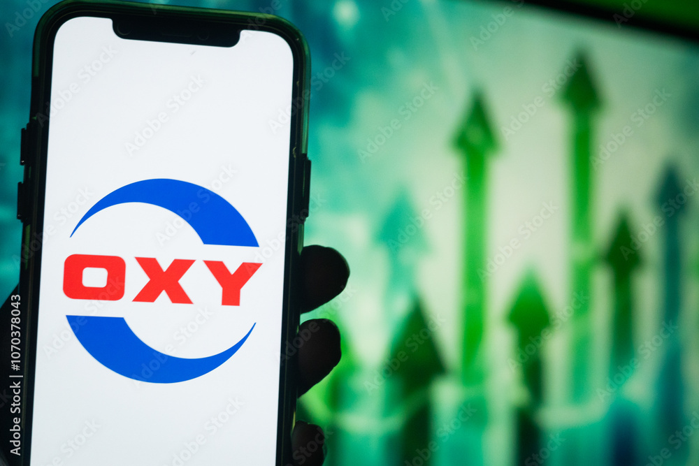 Hand Holding Phone with Occidental Petroleum Corp (OXY) Logo and ...