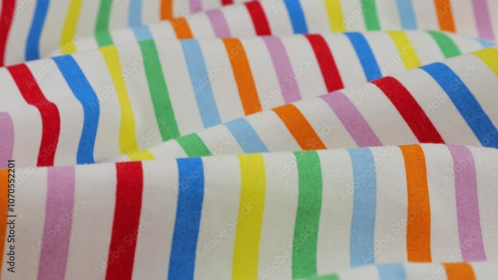 The white cotton fabric with rainbow stripes rotated on the display ...