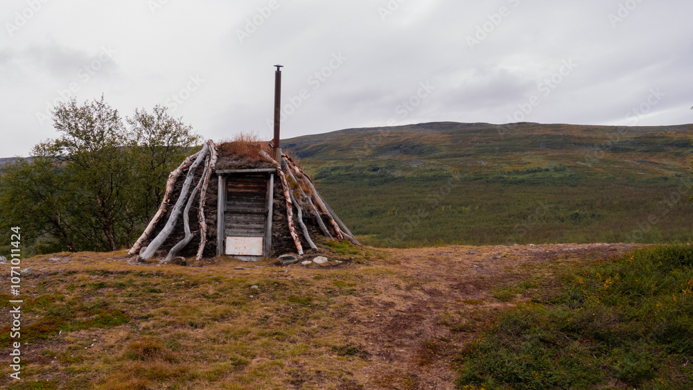 Sami hunting hut with chimney placed in the harsh swedish Lapland ...