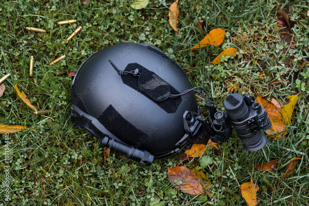 Black military ballistic helmet with night vision device and flashlight ...