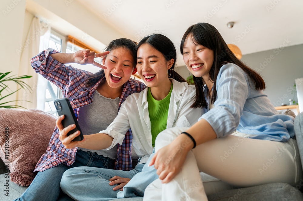 Happy beautiful chinese women friends bonding at home - Playful pretty ...
