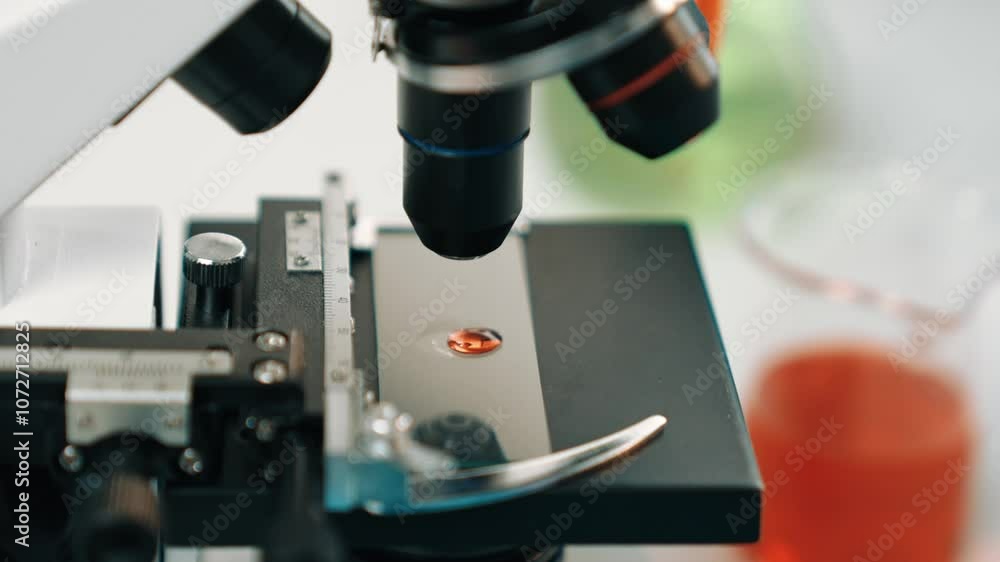 Scientific laboratory researcher drop blood sample on microscopic slide ...