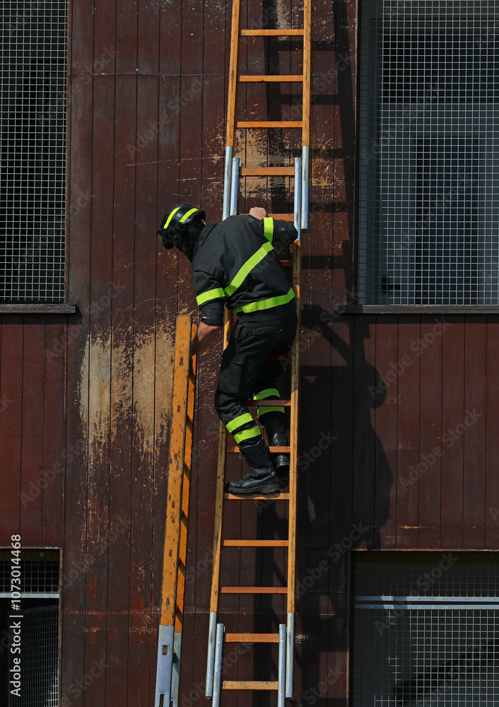 Poster firefighter setting up ladder during training session at fire ...