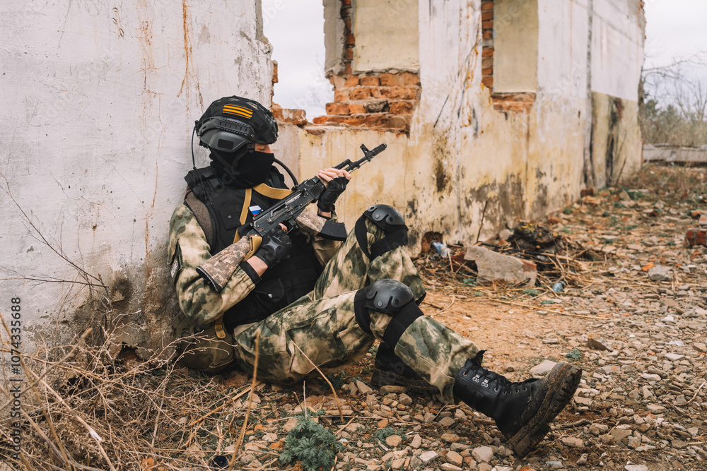 Russian special forces soldier holds a Kalashnikov assault rifle in his ...
