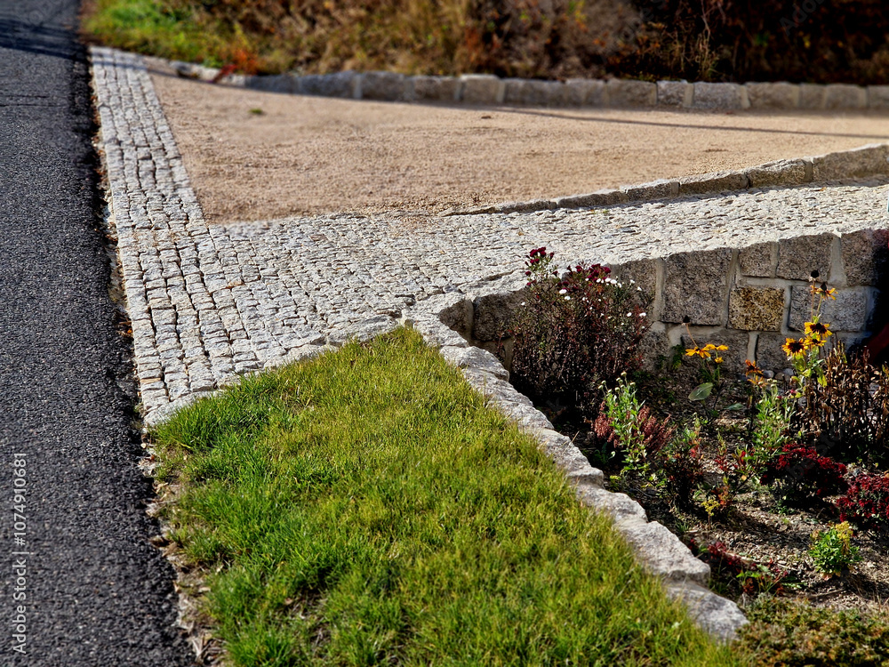 connecting the driveway to the asphalt road. paving stones and ...