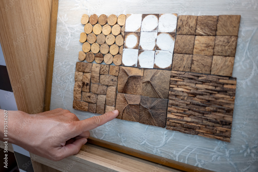 Coconut shell mosaic pattern design concept. Designer hand pointing at ...