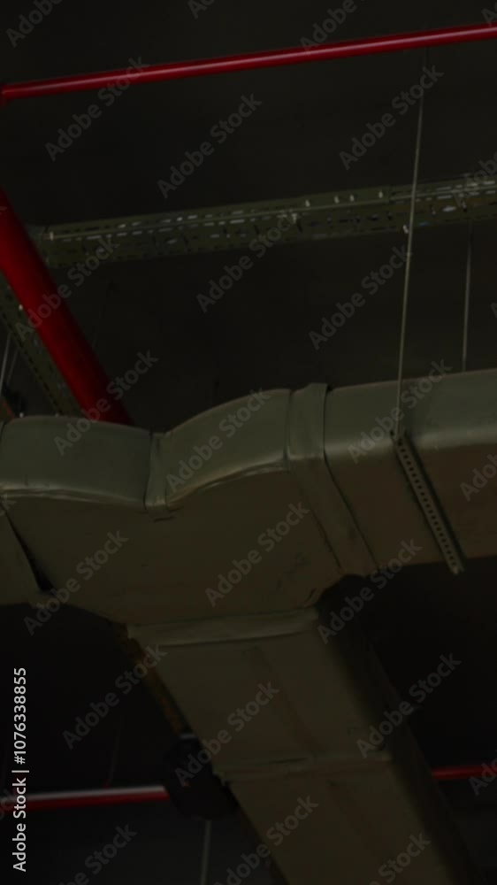 Vertical video. Close-up view of ductwork and pipes in an industrial ...