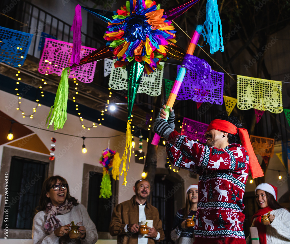 Mexican Posada and family breaking a traditional pinata to celebrate ...
