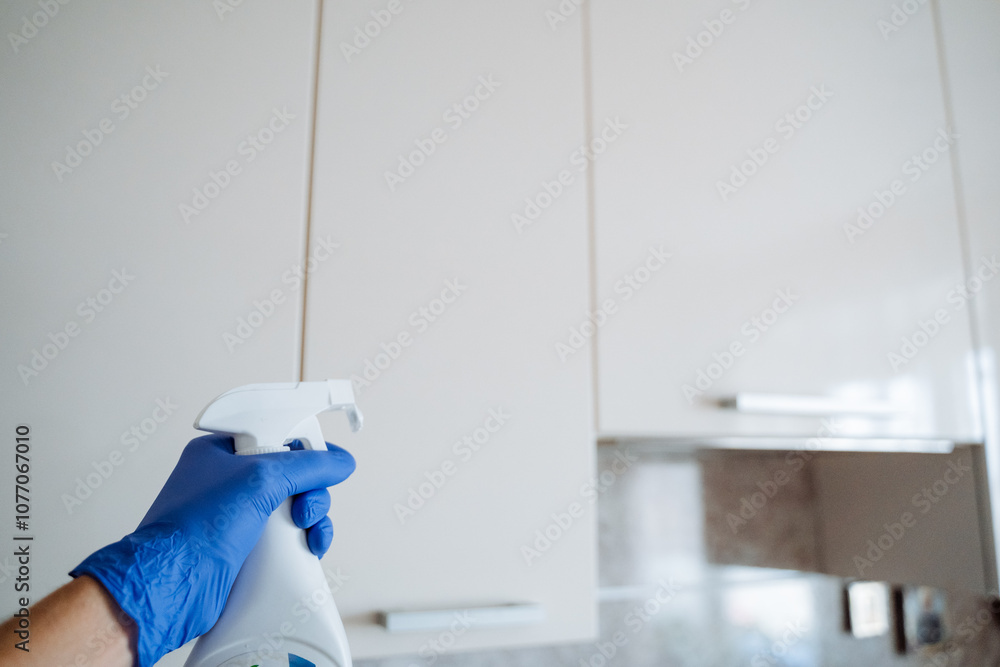 In a clean kitchen, a person in electric blue gloves shows safe ways to ...
