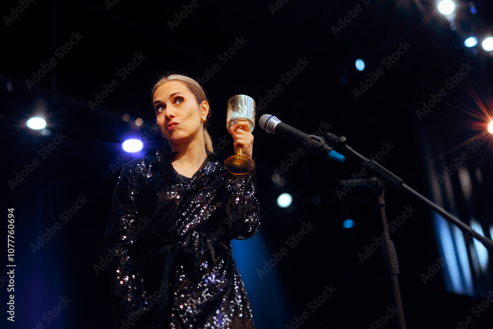 Woman Toasting with a Glass on Stage Celebrating. Cheerful party ...