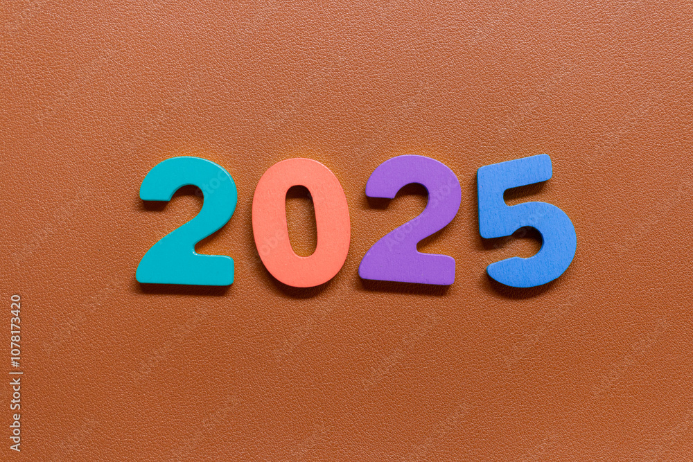 Colorful numbers 2025 on a brown textured background. Perfect for ...