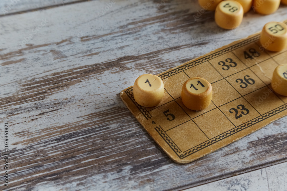 A bingo token with the number one on a playing card on an old worn ...