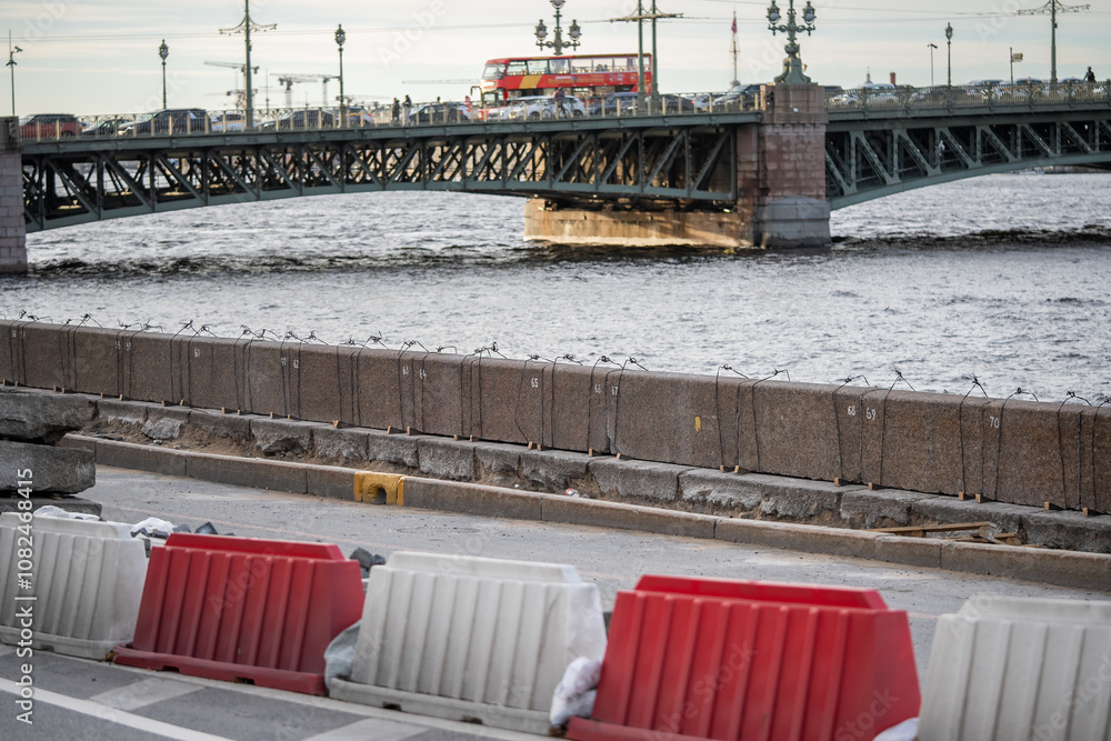 Neva river embankment maintenance. Replacing and aligning granite slabs ...